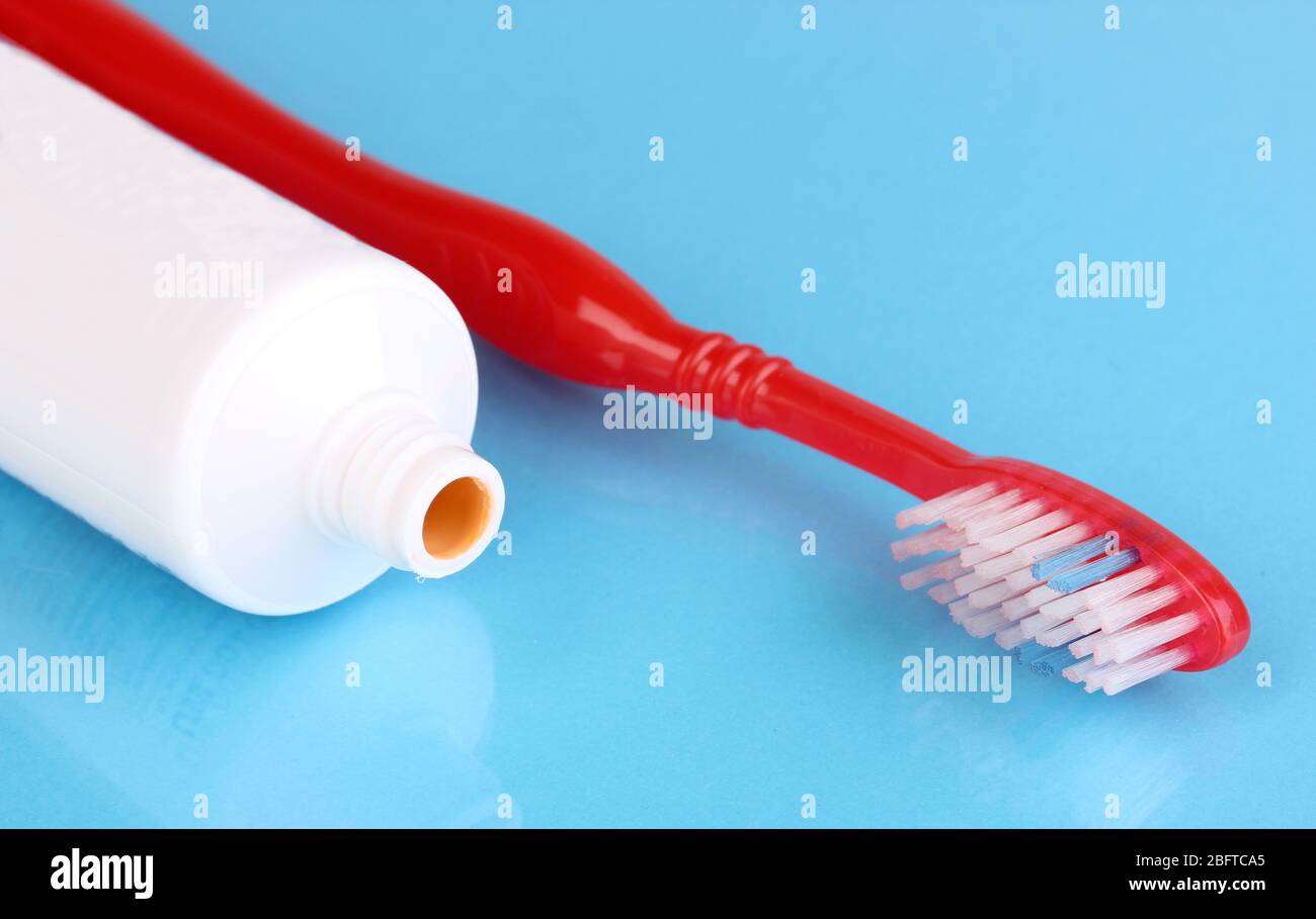 Toothbrush and paste on blue background Stock Photo - Alamy