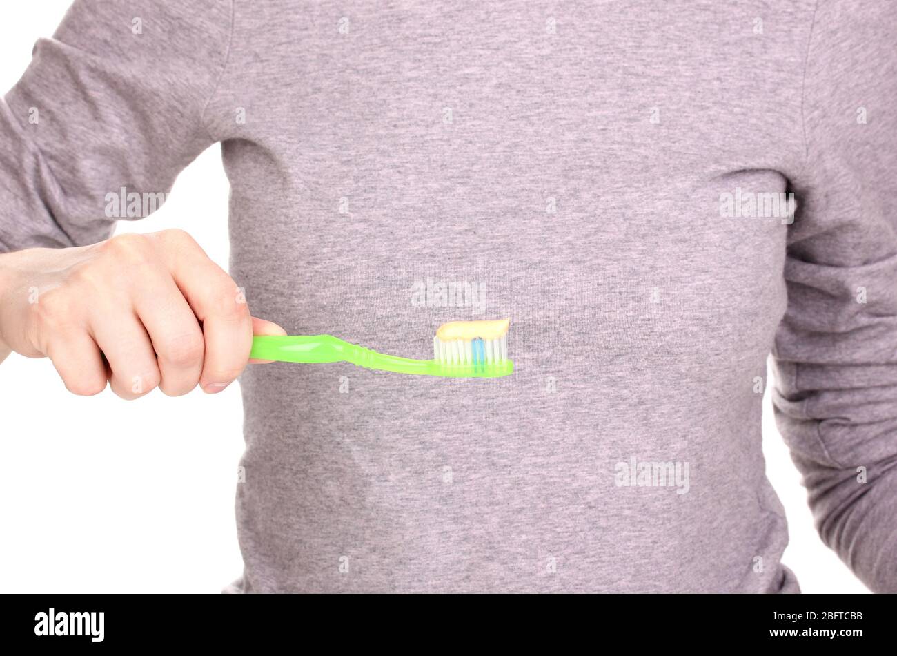 Toothbrush with paste in hand isolated on white Stock Photo - Alamy