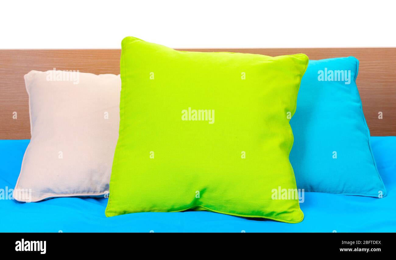 bright pillows on bed on white background Stock Photo - Alamy