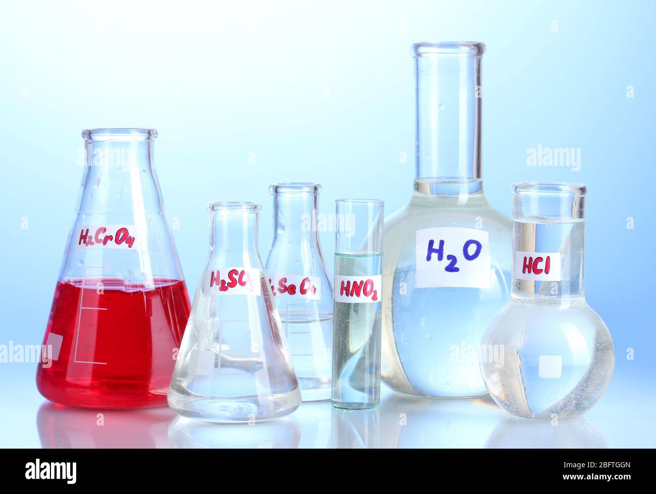 Test-tubes with various acids on blue background Stock Photo - Alamy