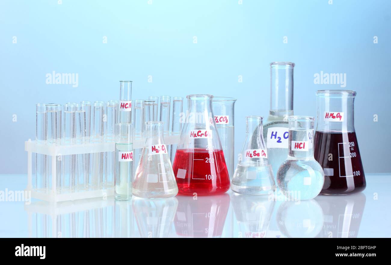 Test-tubes with various acids on blue background Stock Photo - Alamy