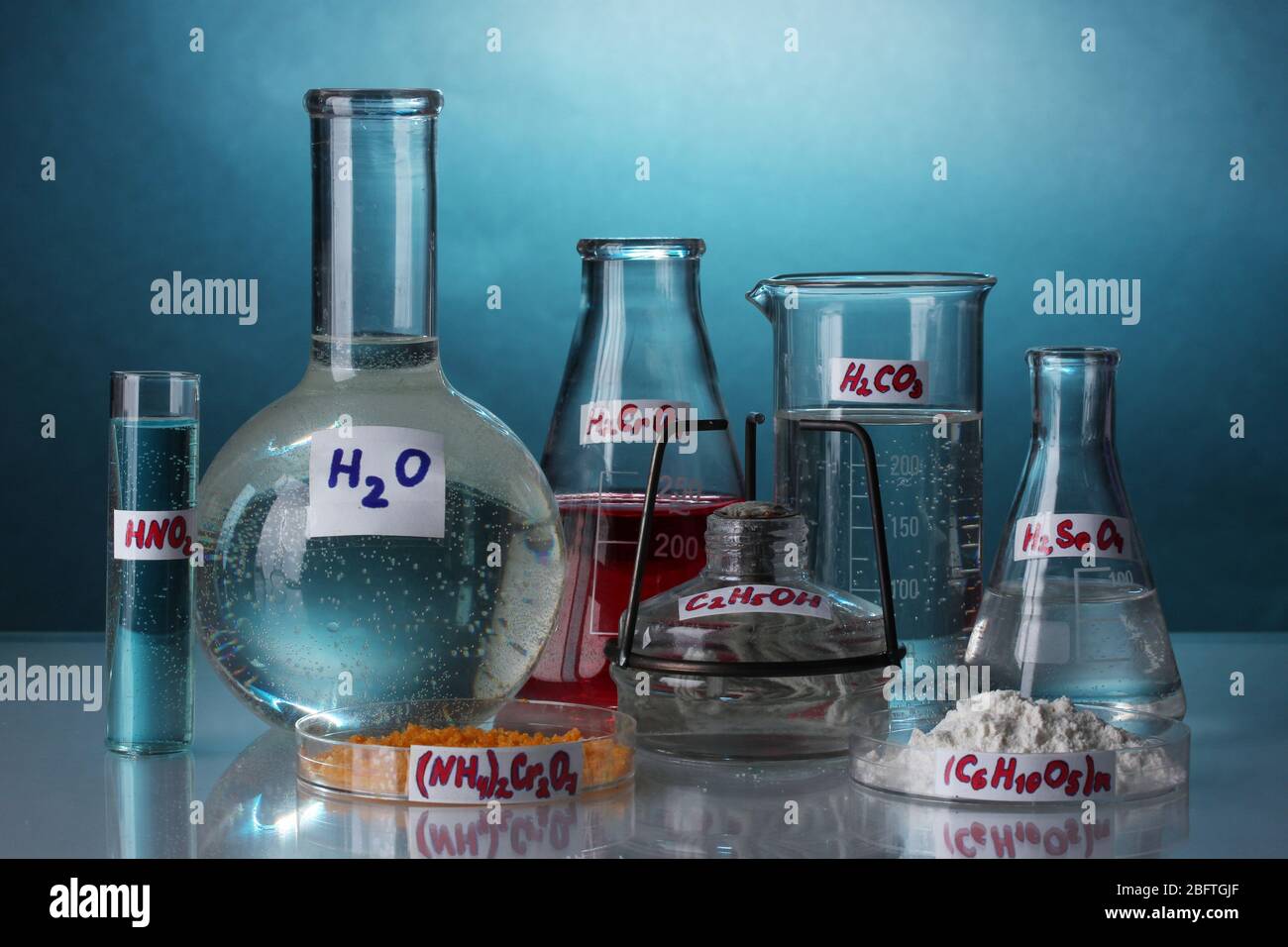 Test-tubes with various acids and chemicals on bright background Stock ...