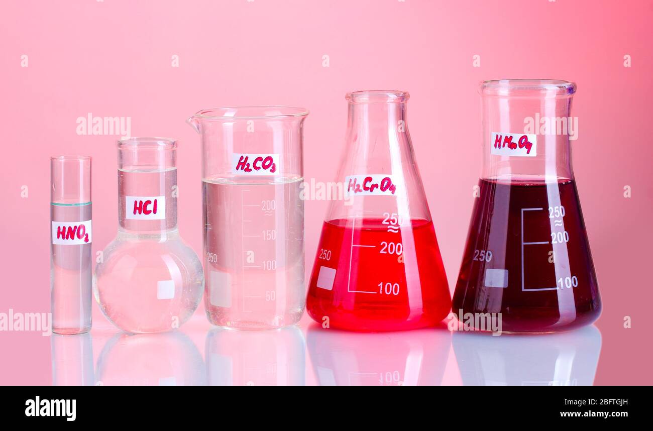Test-tubes with various acids on pink background Stock Photo - Alamy