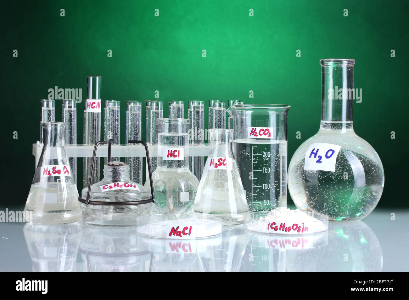 Test-tubes with various acids and chemicals on bright background Stock ...