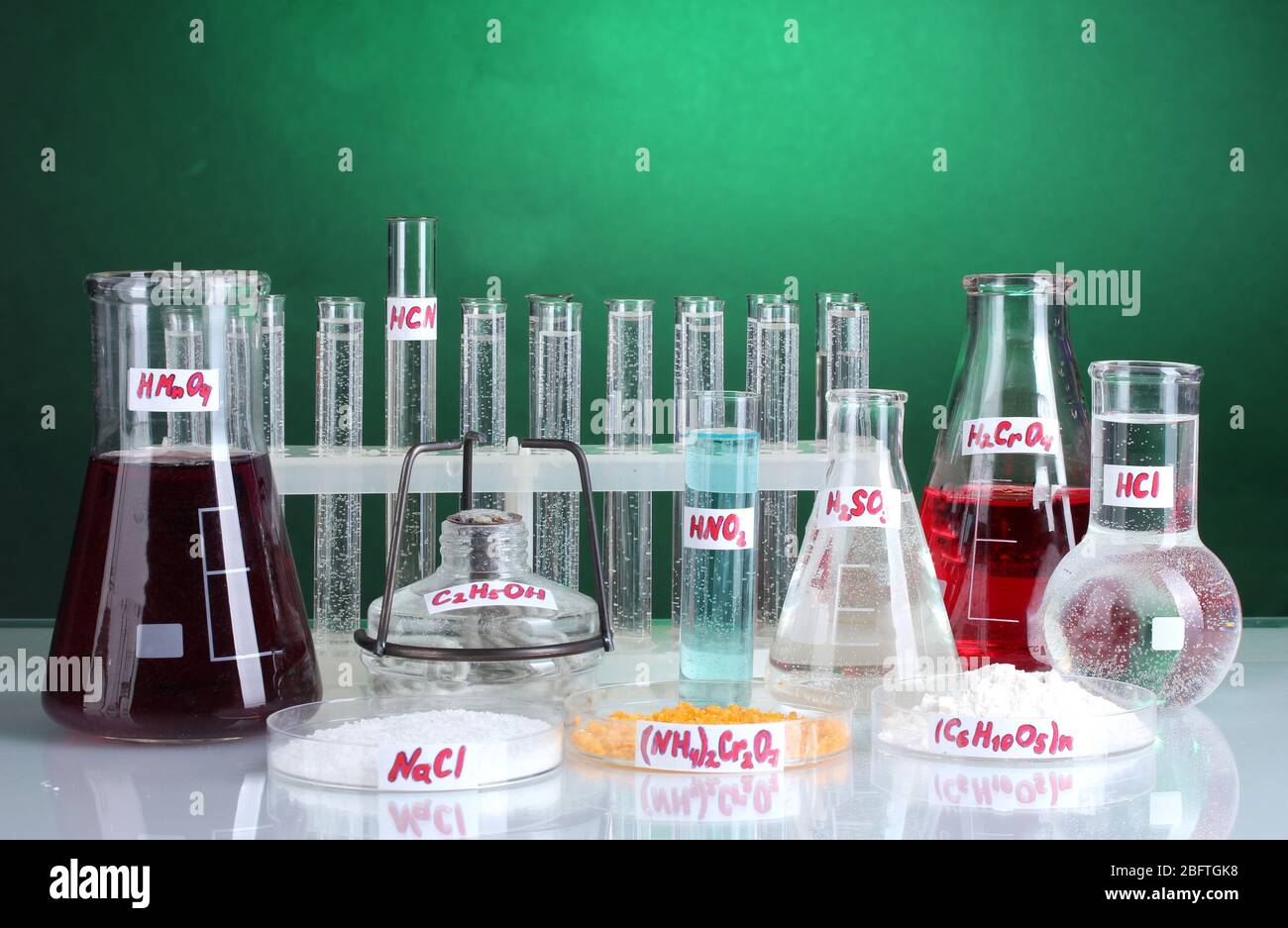 Test-tubes with various acids and chemicals on bright background Stock ...