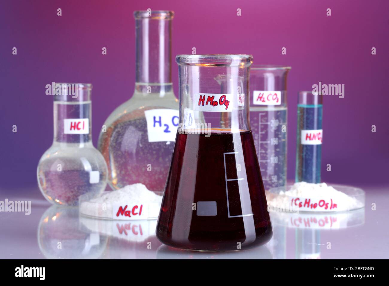 Test-tubes with various acids and chemicals on violet background Stock ...