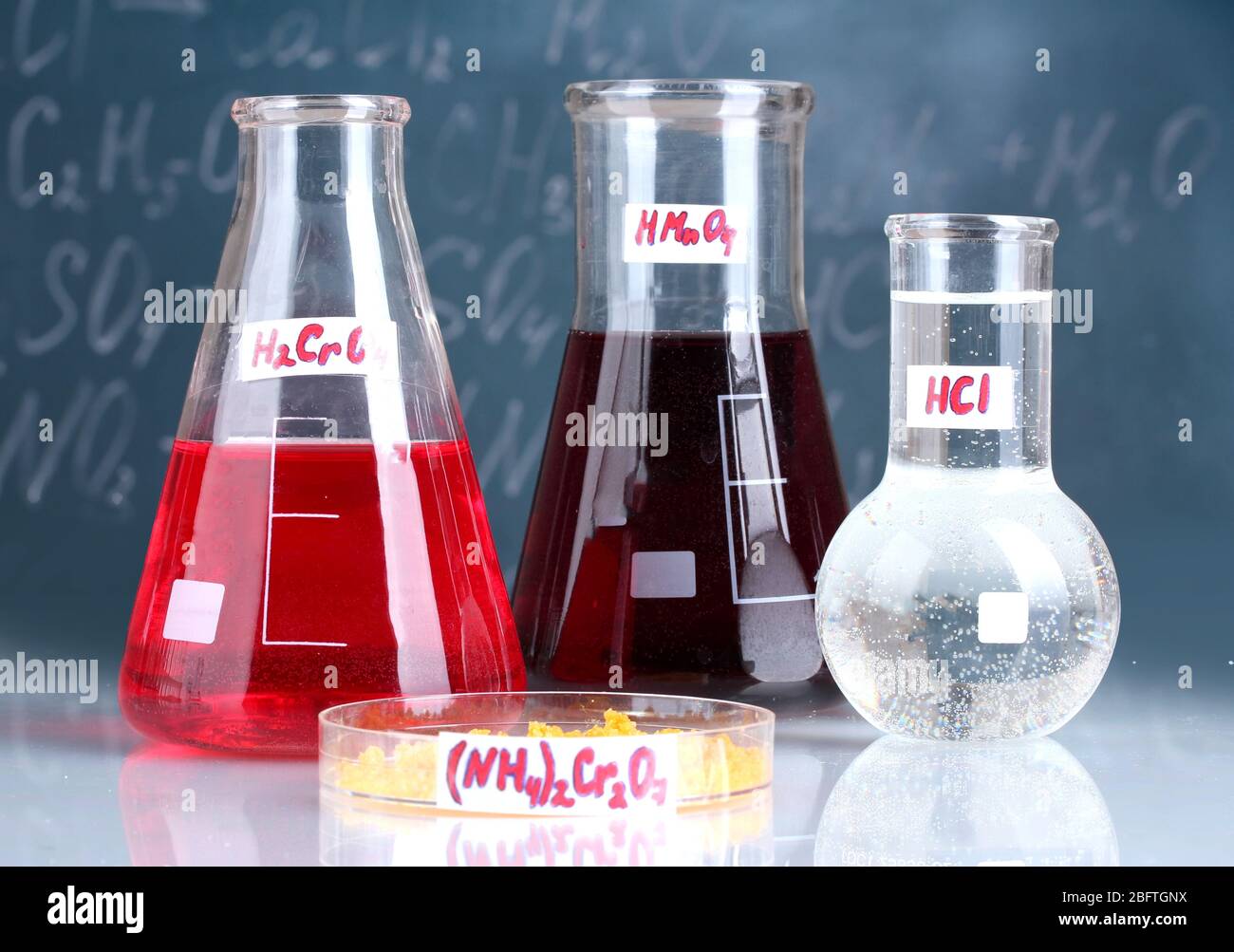 Test-tubes with various acids and other chemicals on the background of ...
