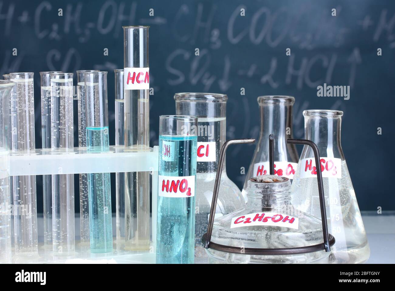 Test-tubes with various acids and other chemicals on the background of ...