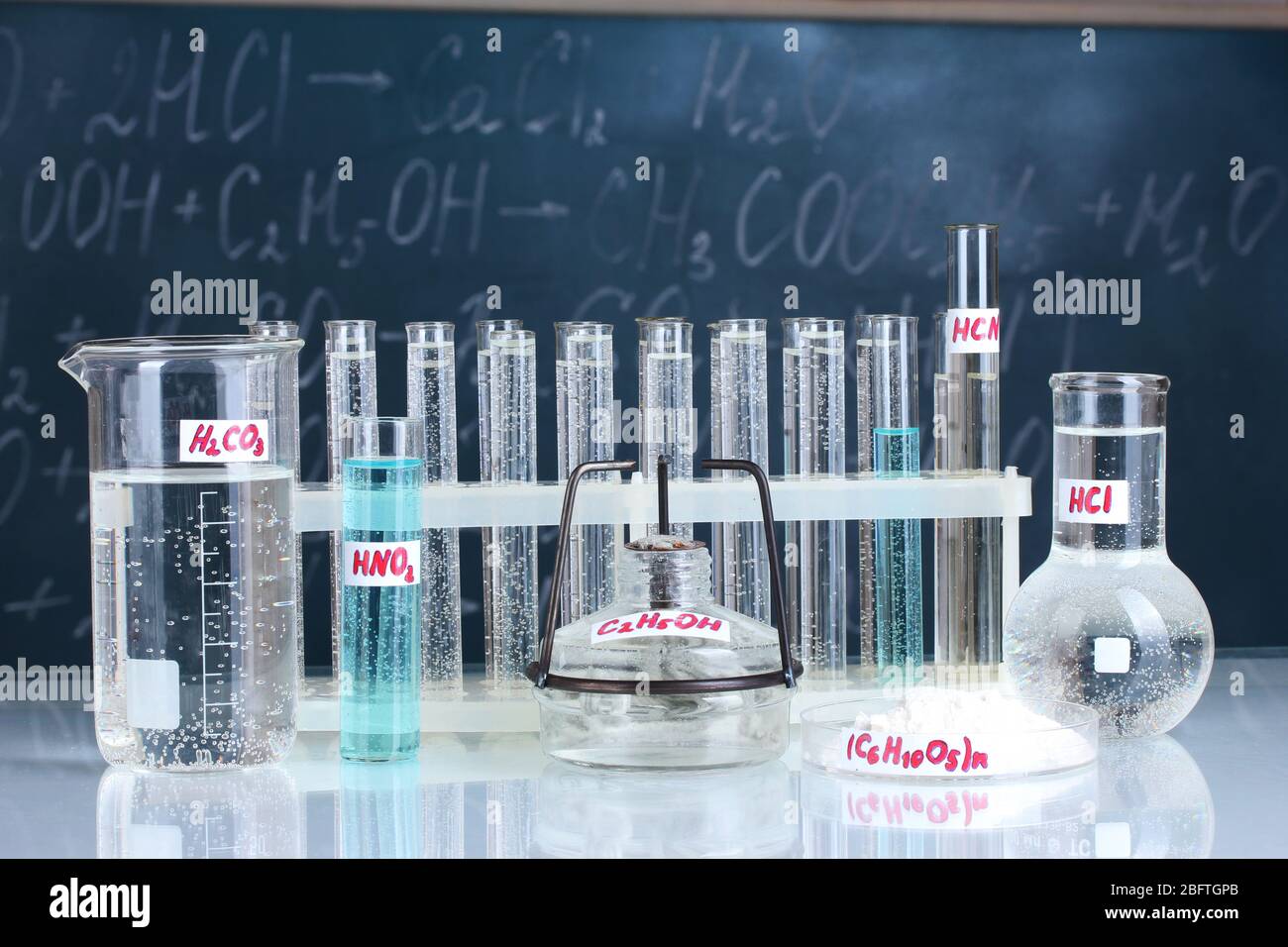 Test-tubes with various acids and other chemicals on the background of ...