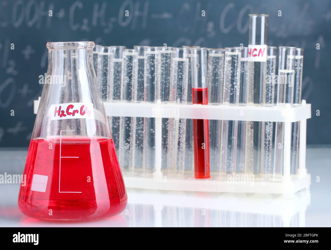 Test-tubes with various acids and other chemicals on the background of ...