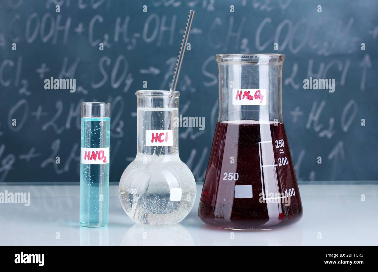 Test-tubes with various acids and other chemicals on the background of ...