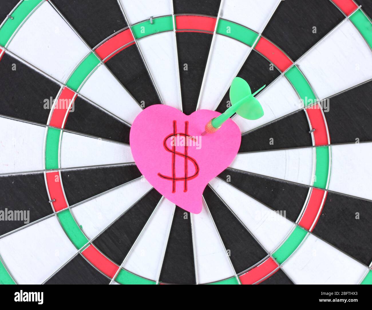 Darts with stickers depicting the life values close-up on white ...