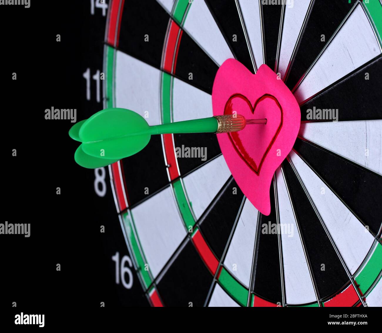 Darts with stickers depicting the life values close-up on black ...