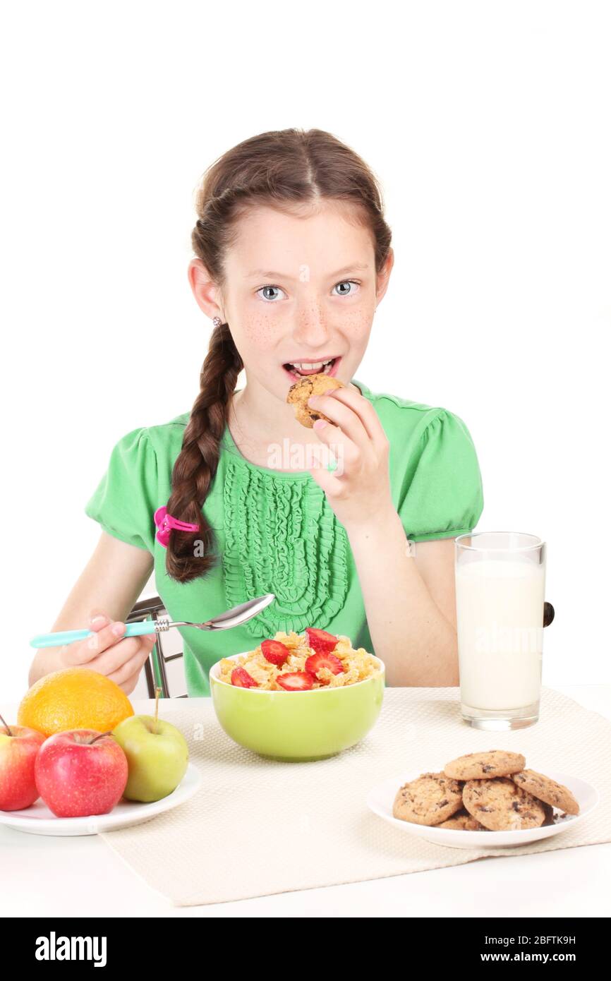 little beautiful girl have a breakfast on white background Stock Photo ...