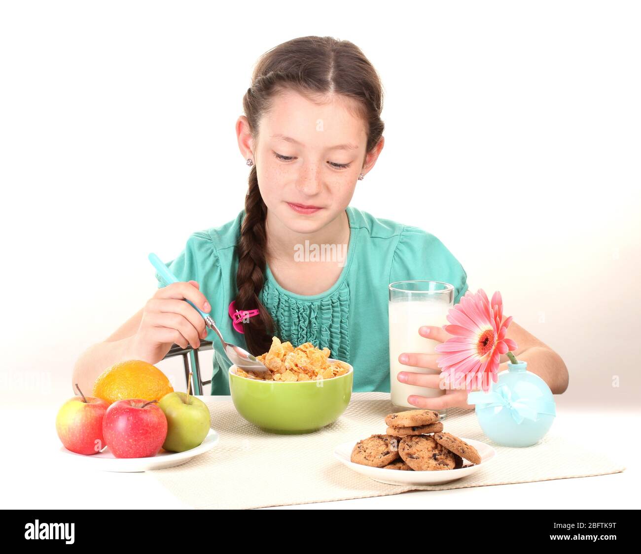 little beautiful girl have a breakfast on white background Stock Photo ...