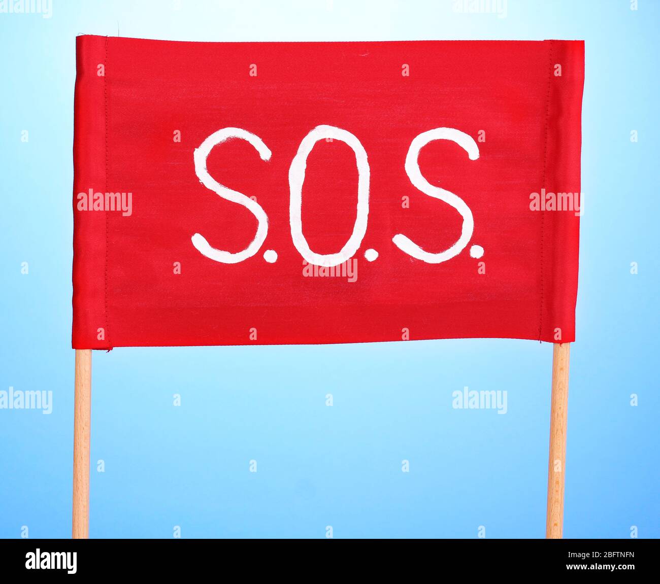 SOS signal written on red cloth on blue background Stock Photo - Alamy