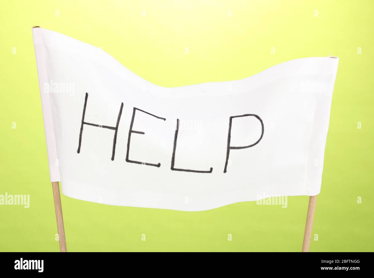 Help written on white cloth on green background Stock Photo - Alamy