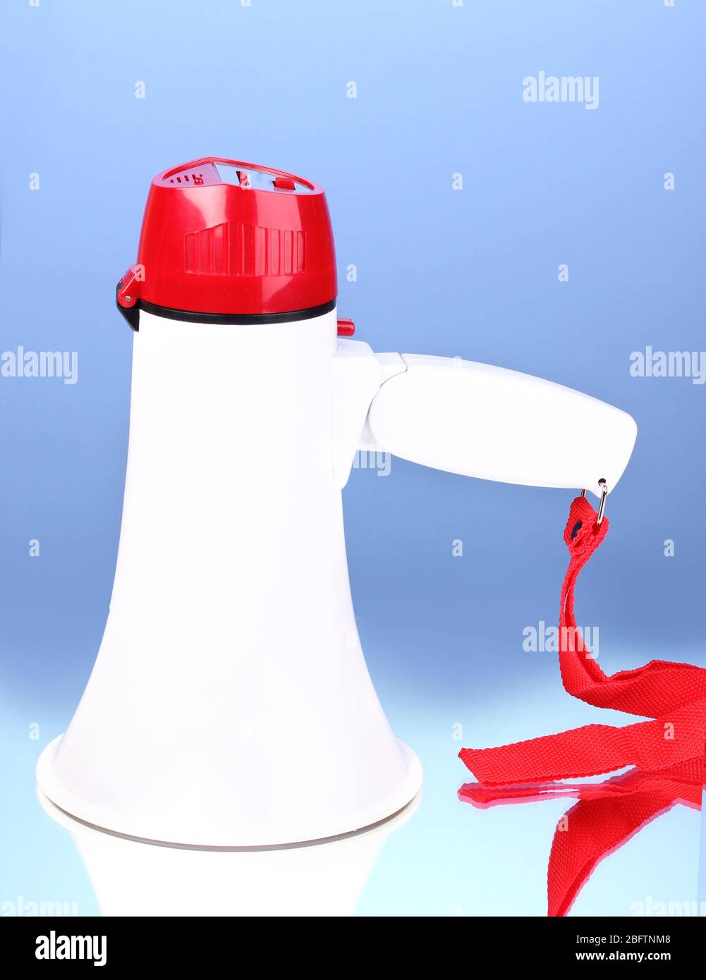 red and white megaphone on blue background Stock Photo - Alamy