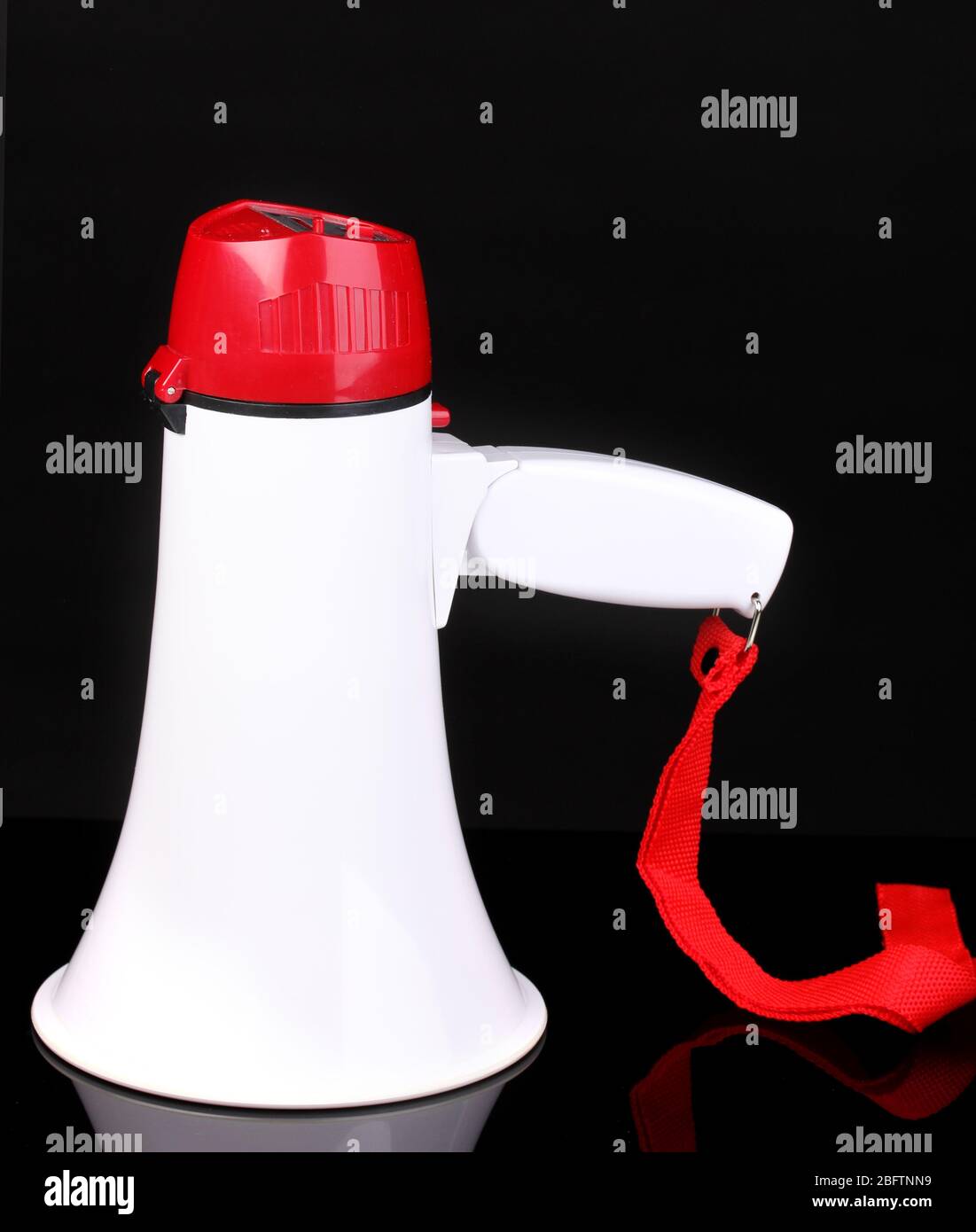 red and white megaphone isolated on black Stock Photo - Alamy