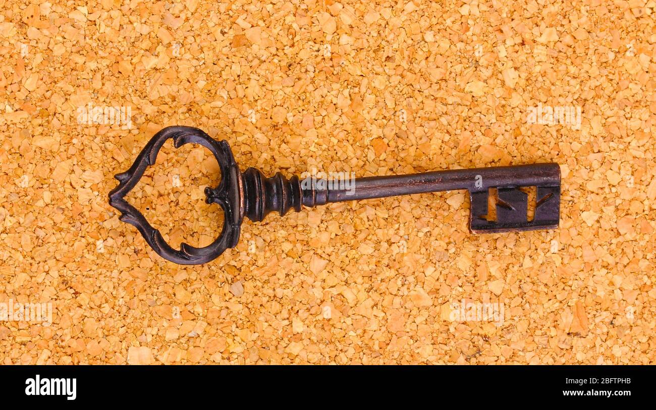 Antique key on cork background Stock Photo - Alamy