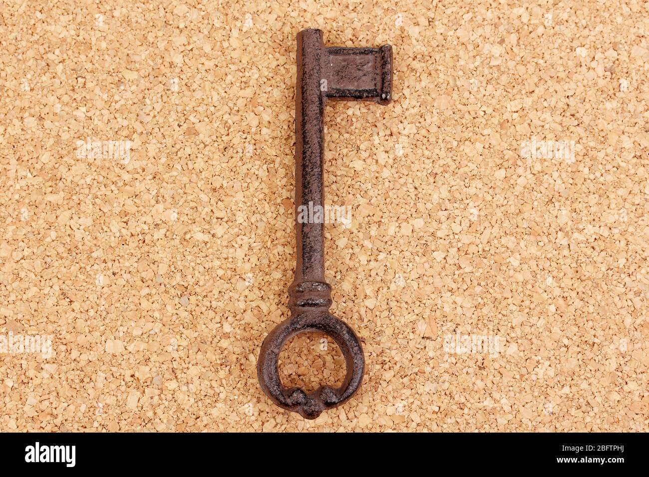 Antique key on cork background Stock Photo - Alamy