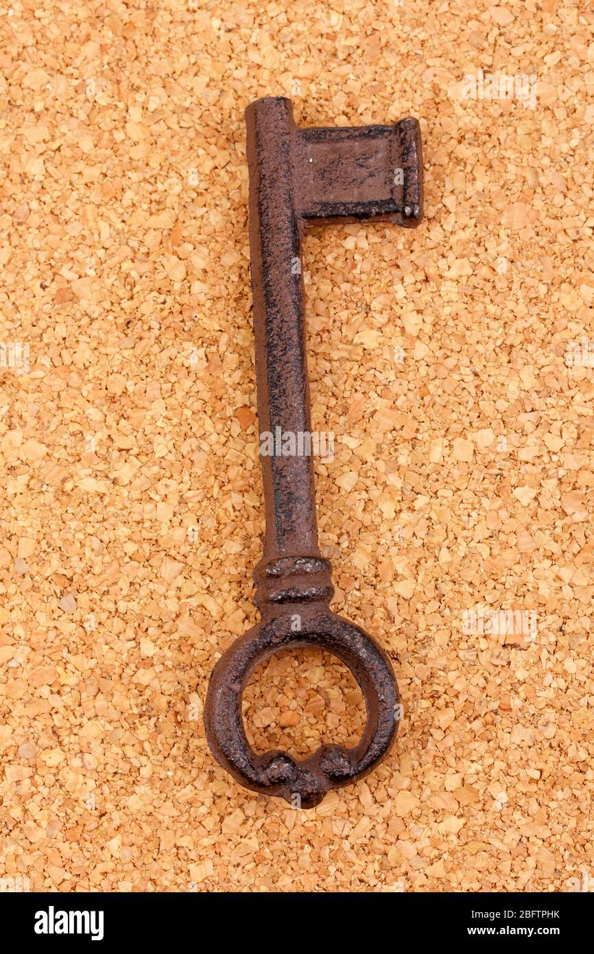 Antique key on cork background Stock Photo - Alamy