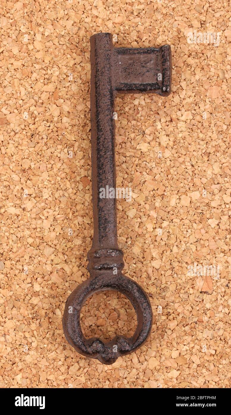 Antique key on cork background Stock Photo - Alamy
