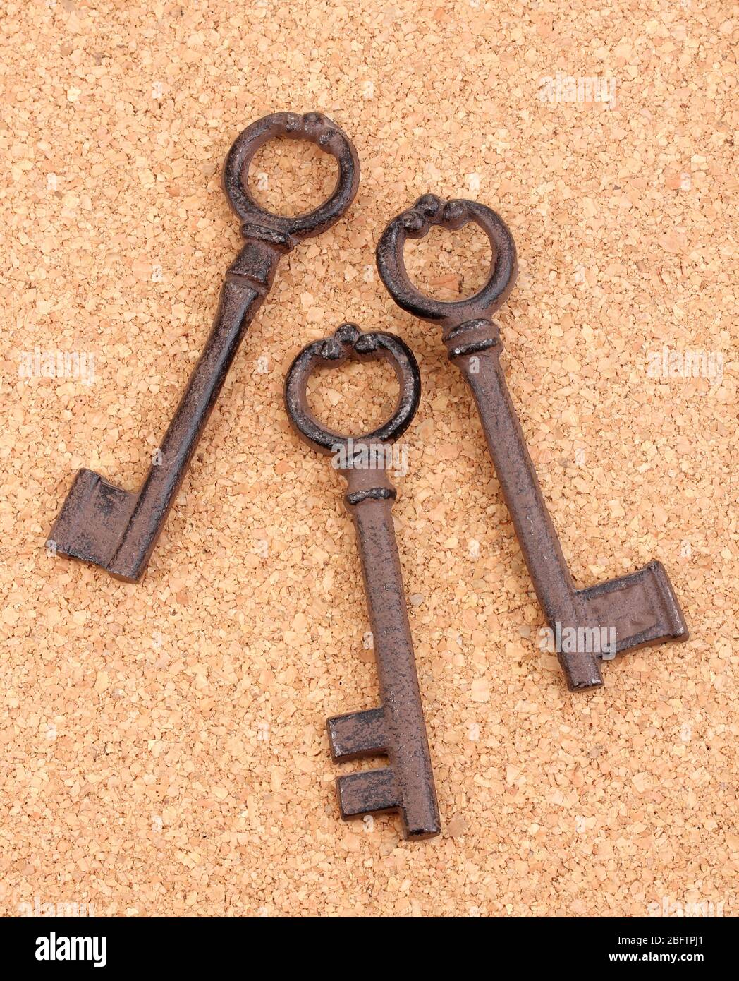 a bunch of antique keys on cork background Stock Photo - Alamy