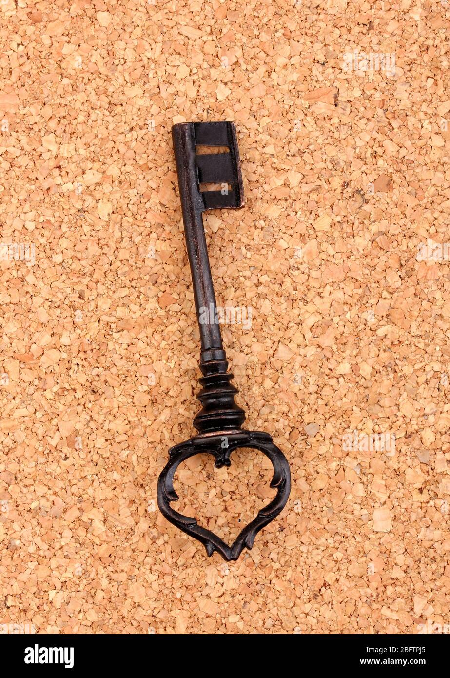 Antique key on cork background Stock Photo - Alamy