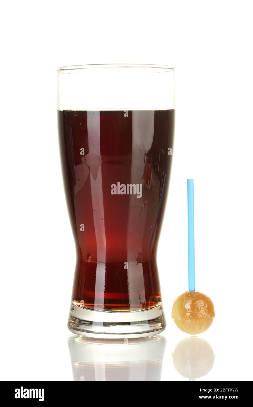 Lollipop with a taste of cola with a glass of cola isolated on white ...