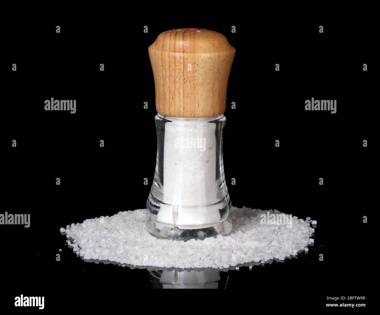Sea salt in the salt shaker isolated on black close-up Stock Photo - Alamy