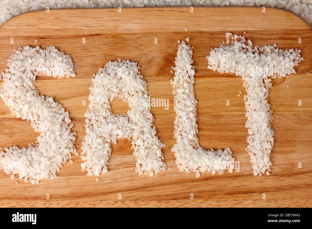 Sea salt on a cutting board close-up Stock Photo - Alamy