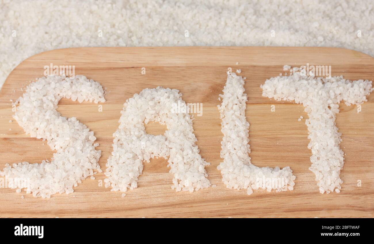 Sea salt on a cutting board close-up Stock Photo - Alamy