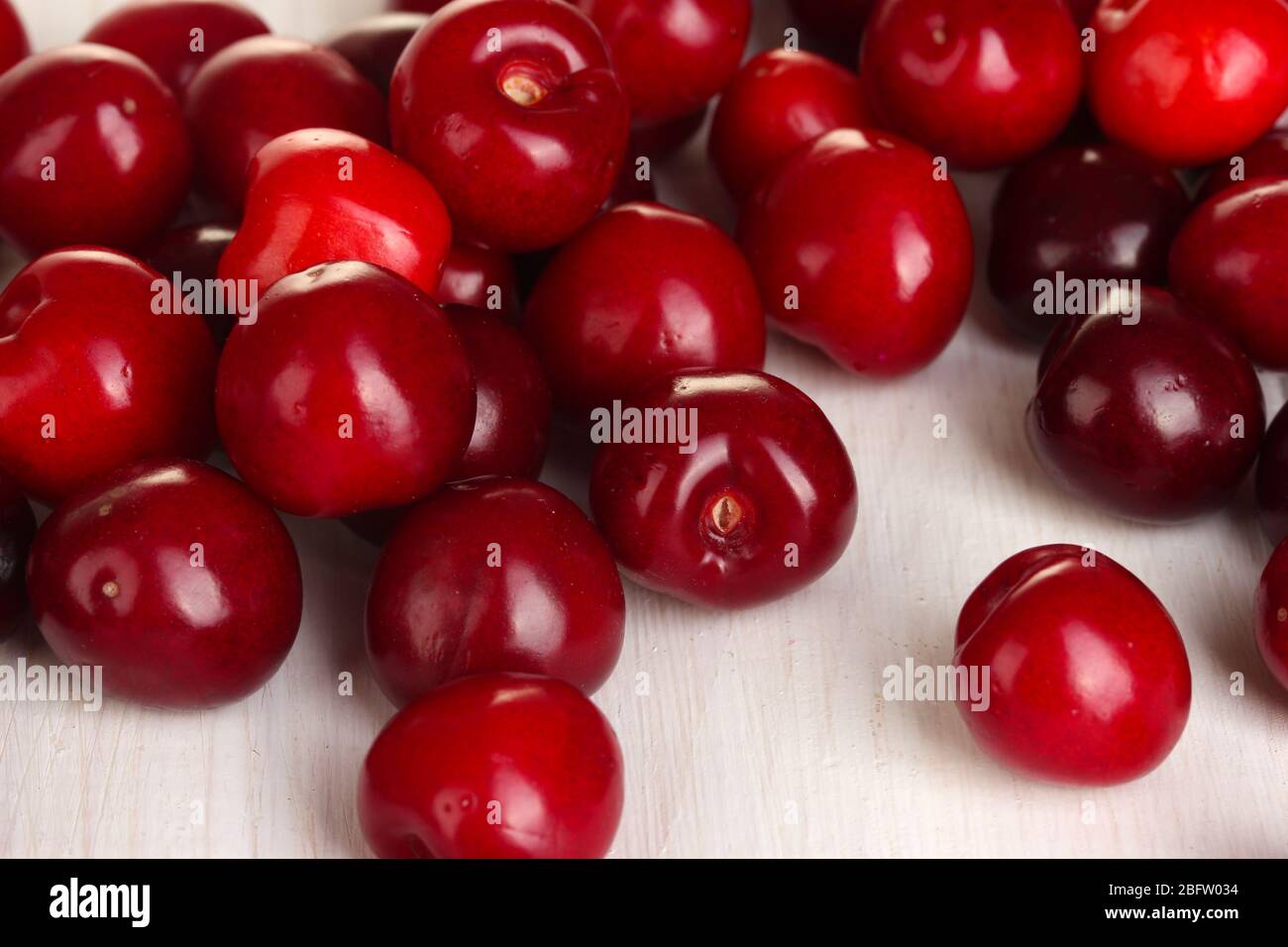 fresh cherry on white wooden table close-up Stock Photo - Alamy