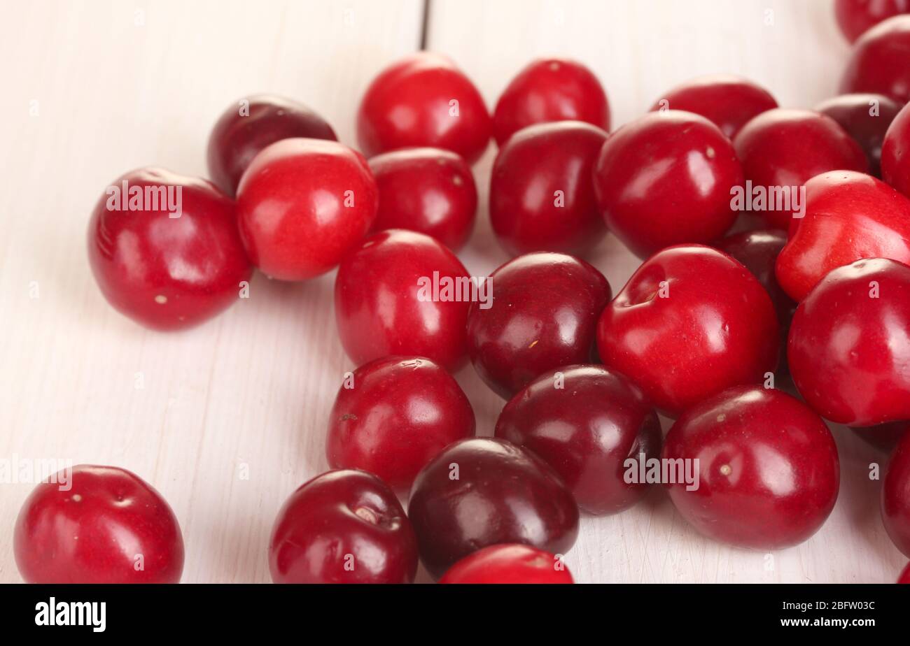 fresh cherry on white wooden table close-up Stock Photo - Alamy