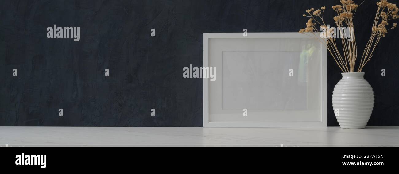 Stylish workspace with mock up frame and copy space, dark grey wall ...