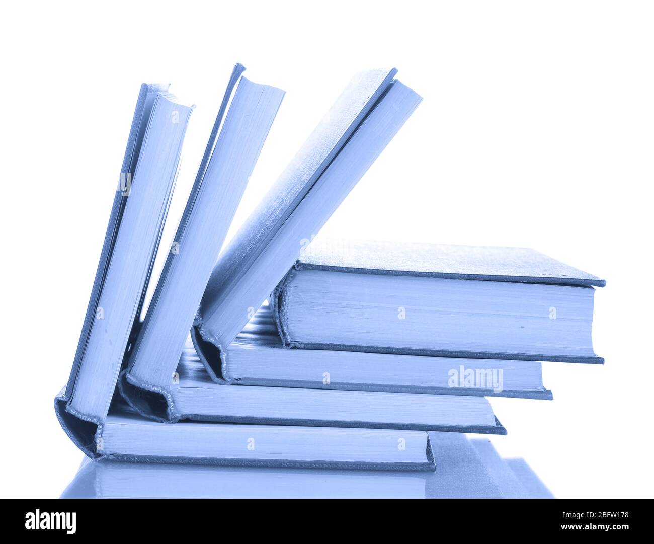 Stack of books in blue light Stock Photo - Alamy