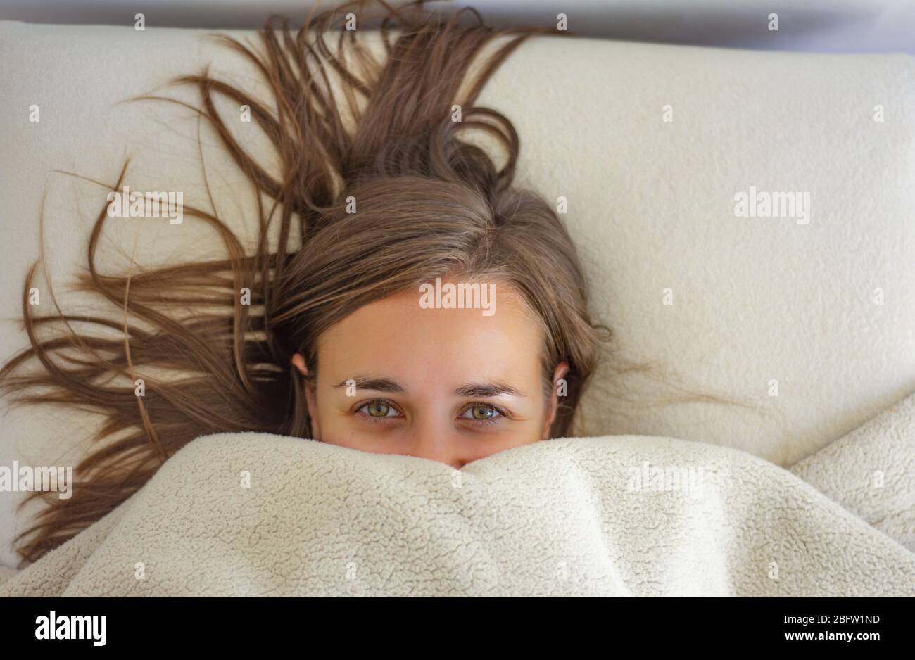 Woman resting in bed covered hi-res stock photography and images - Alamy