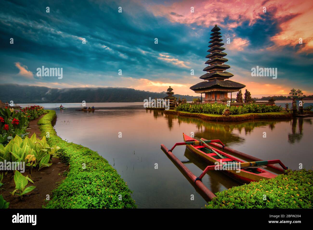 Pura Ulun Danu Bratan, Hindu temple with boat on Bratan lake landscape at sunrise in Bali ...