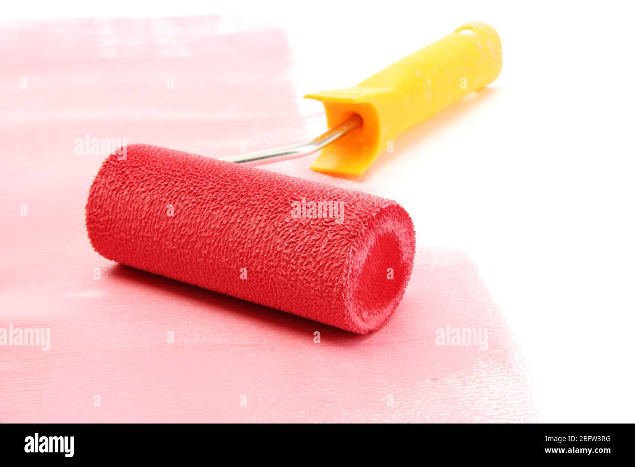 Paint roller with red paint isolated on white Stock Photo - Alamy