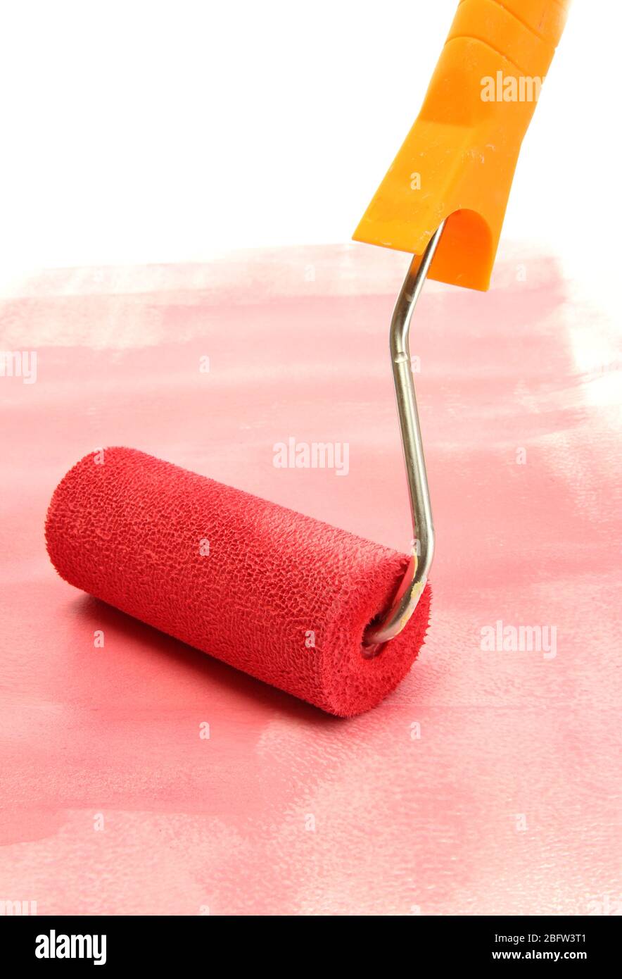 Paint roller with red paint isolated on white Stock Photo - Alamy