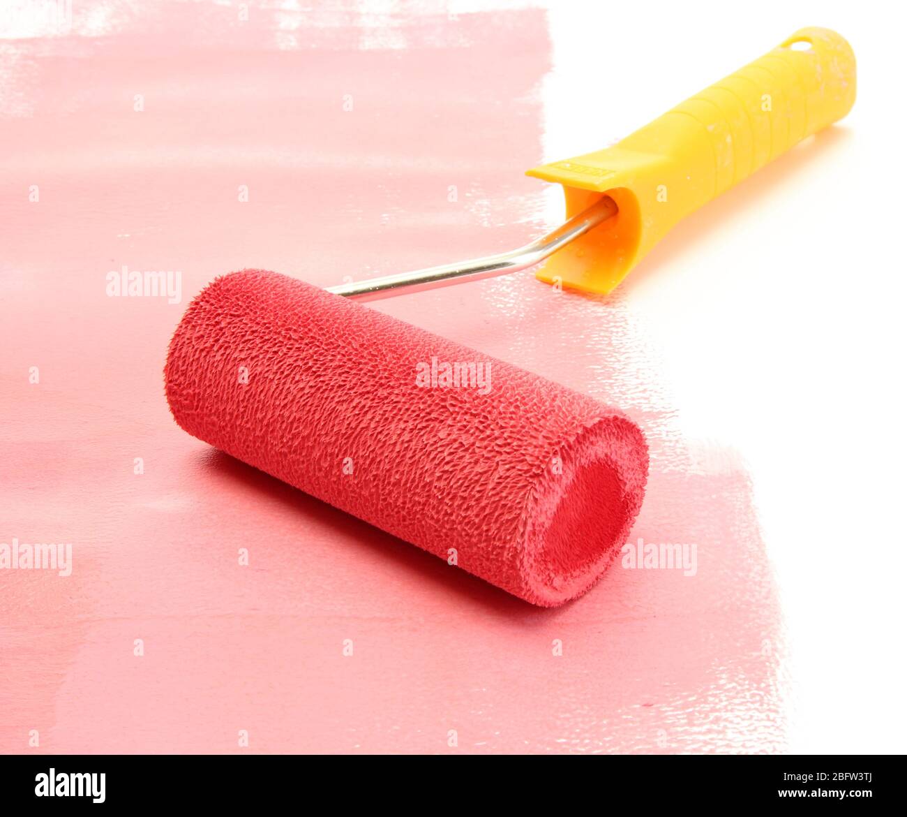 Paint roller with red paint isolated on white Stock Photo - Alamy