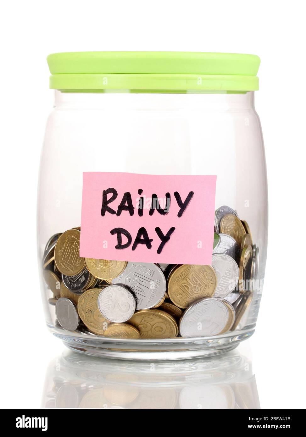 Glass bank for tips with money isolated on white Stock Photo - Alamy