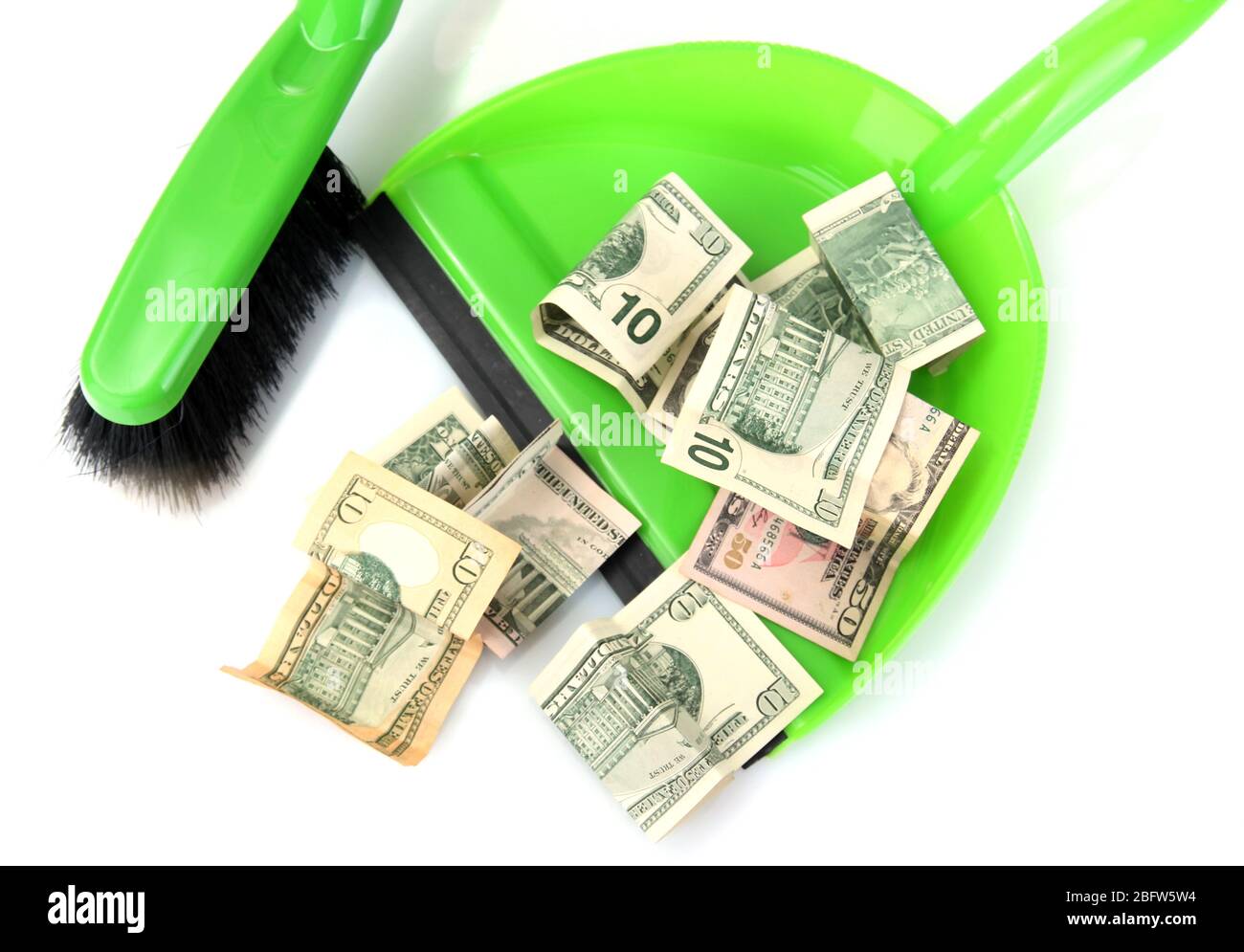Sweeps money in the shovel on white background close-up Stock Photo - Alamy