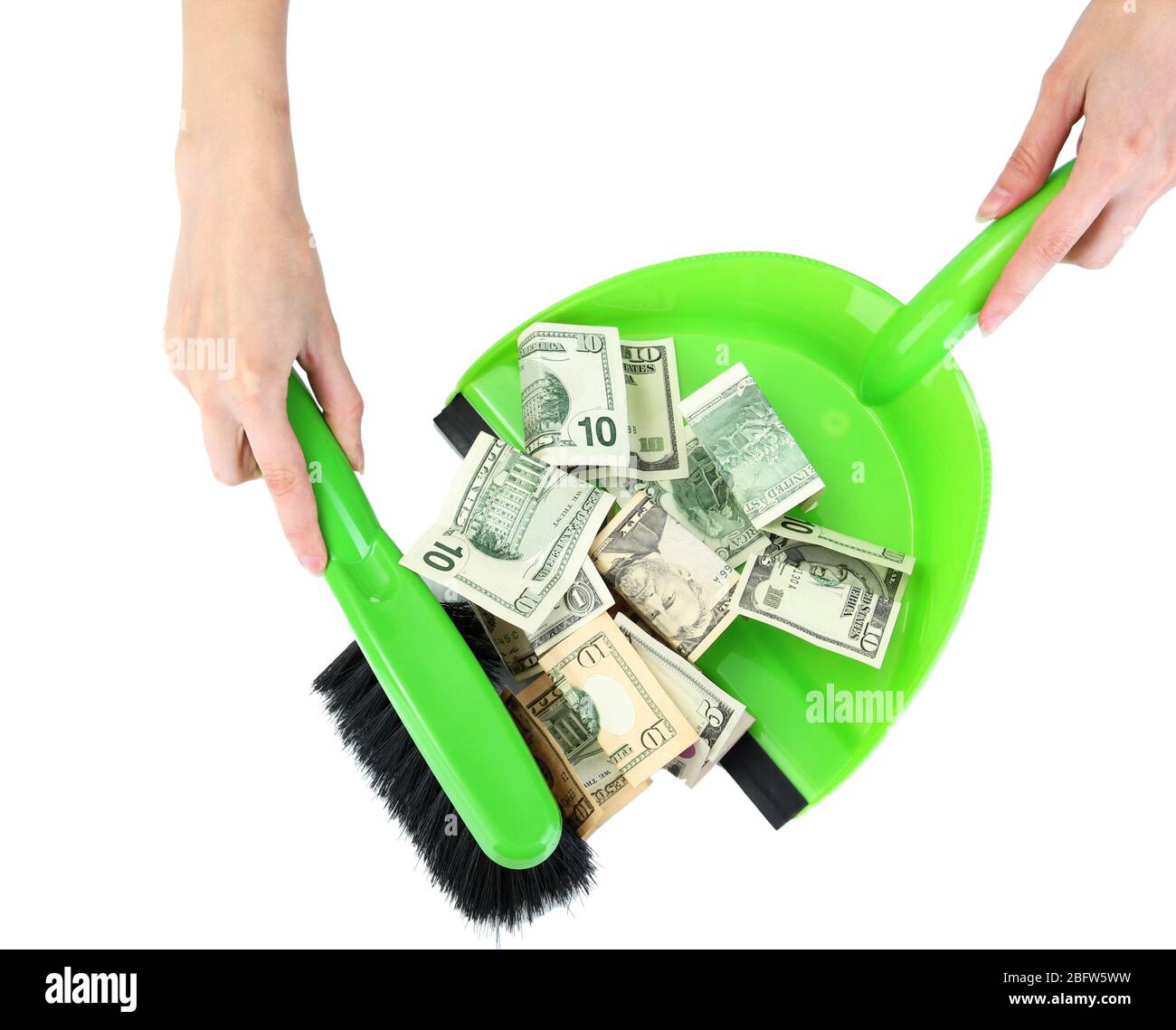 Sweeps money in the shovel on white background close-up Stock Photo - Alamy