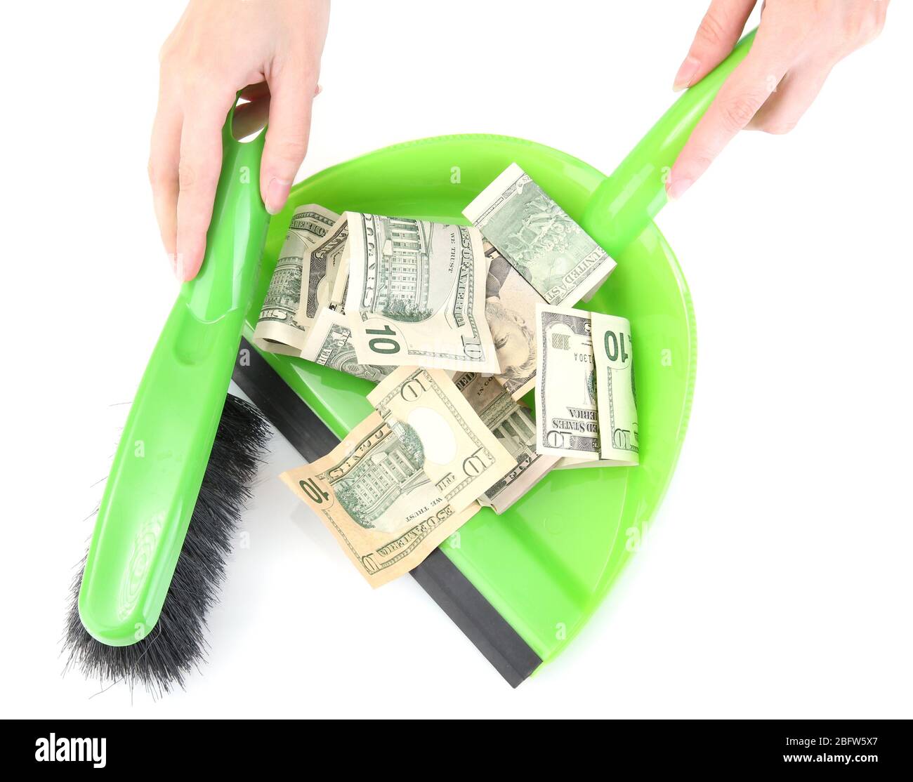 Sweeps money in the shovel on white background close-up Stock Photo - Alamy