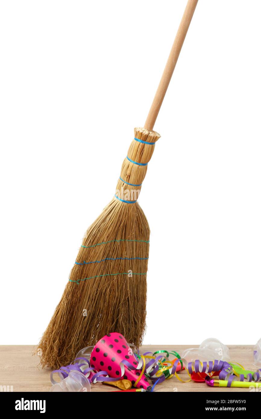 Broom sweep the trash after a party on white background close-up Stock ...