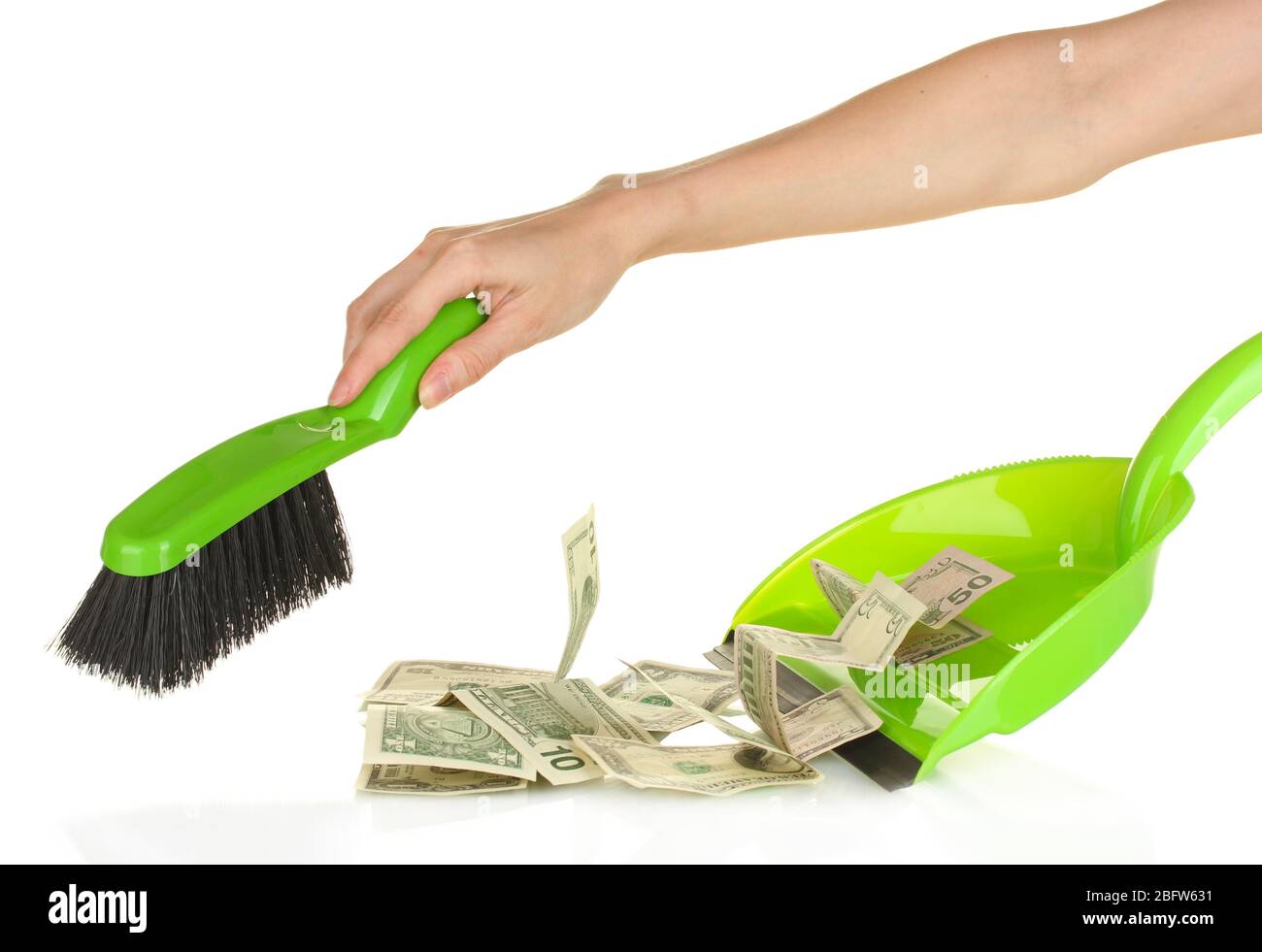Sweeps money in the shovel on white background close-up Stock Photo - Alamy