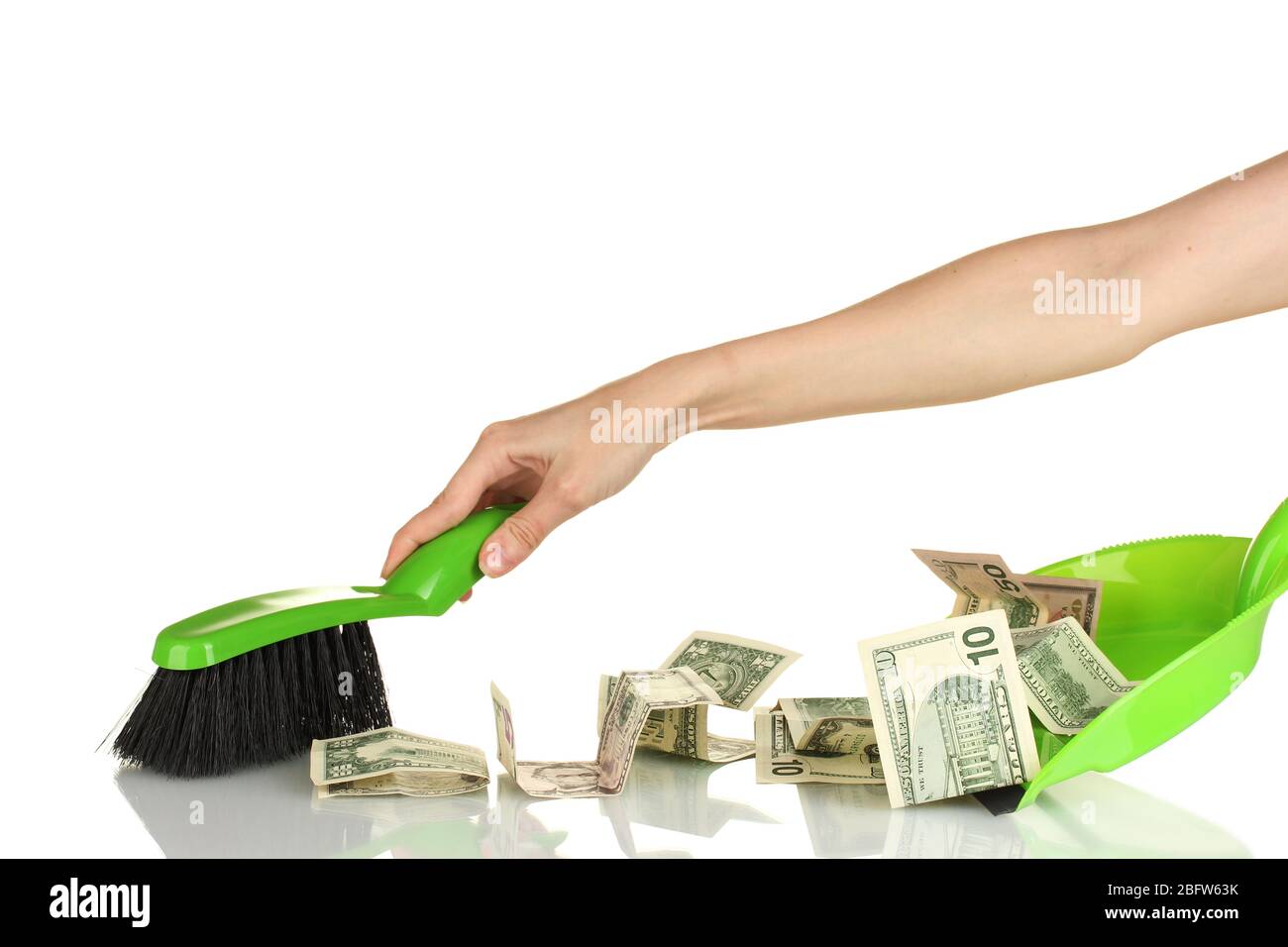 Sweeps money in the shovel on white background close-up Stock Photo - Alamy