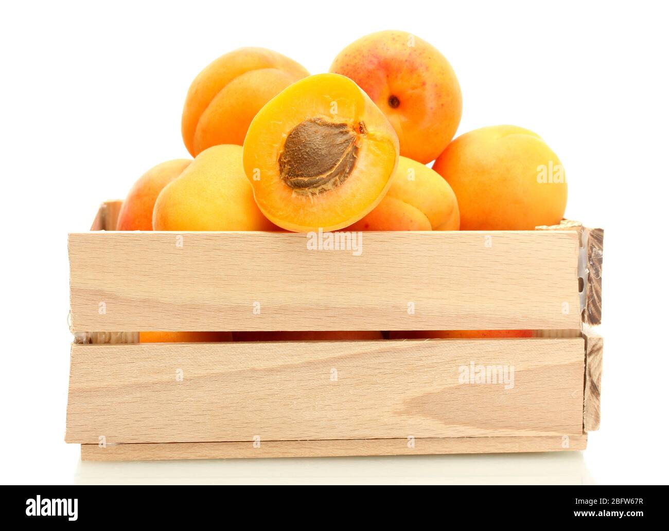 ripe apricots in wooden box isolated on white Stock Photo - Alamy